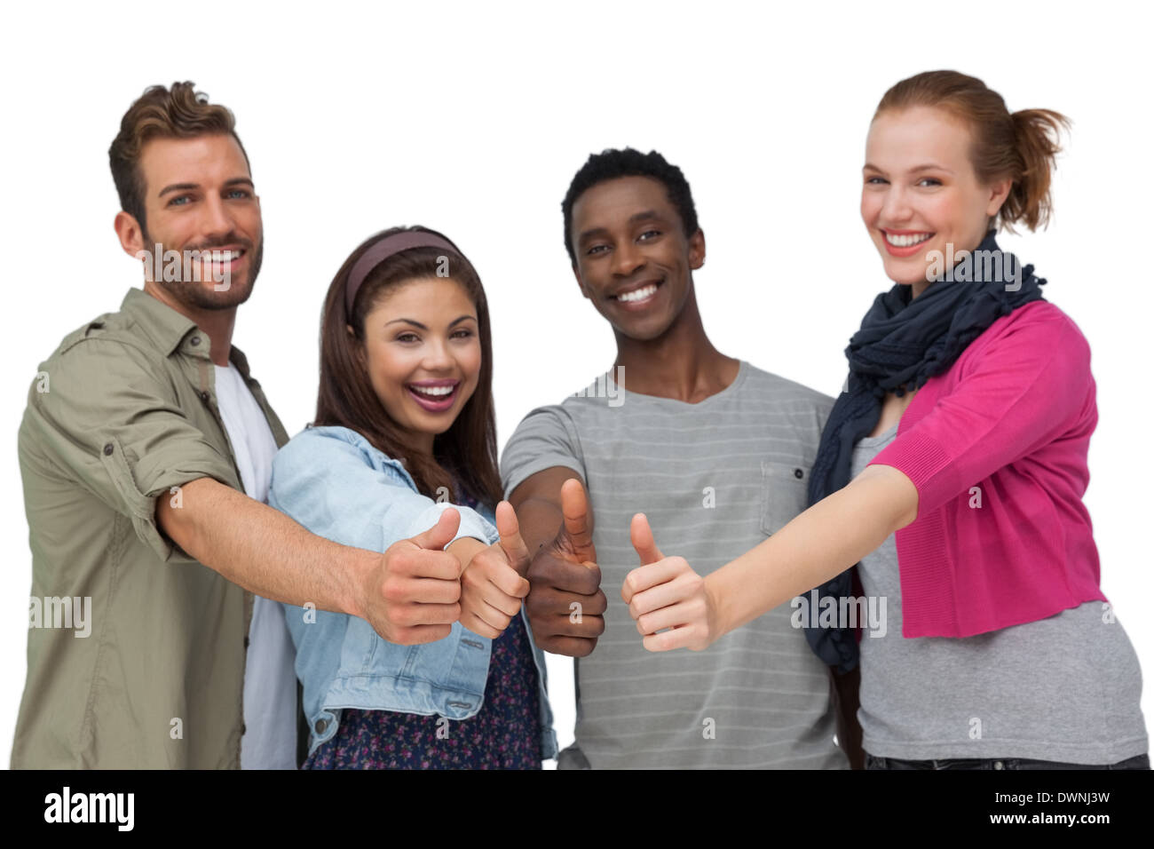 Four happy young friends gesturing thumbs up Stock Photo - Alamy