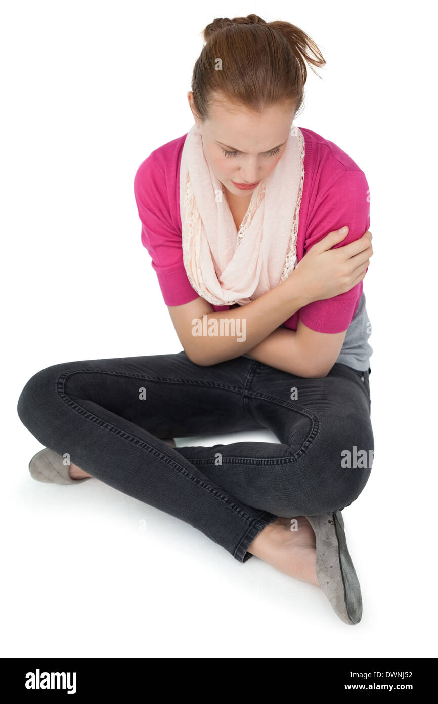 Young woman crossed legs sitting sad hi-res stock photography and ...