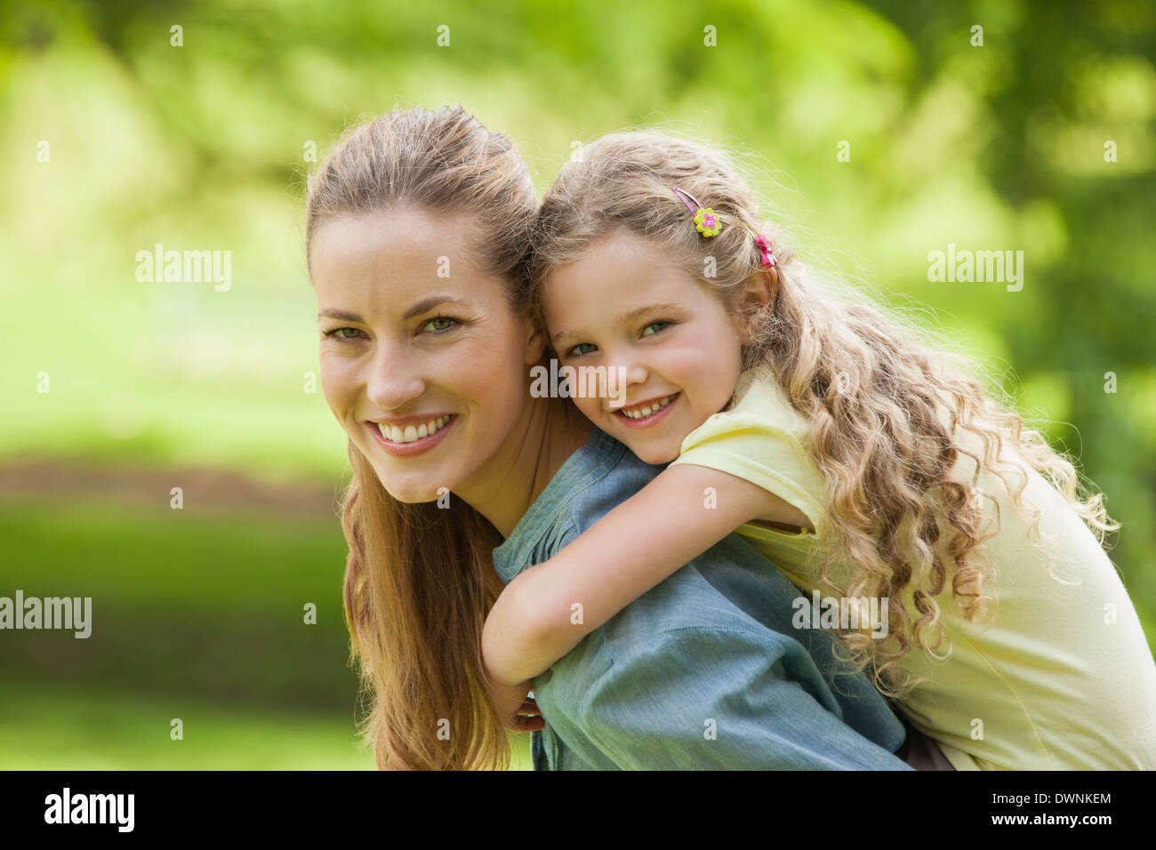 Side view of a woman carrying girl at park Stock Photo - Alamy