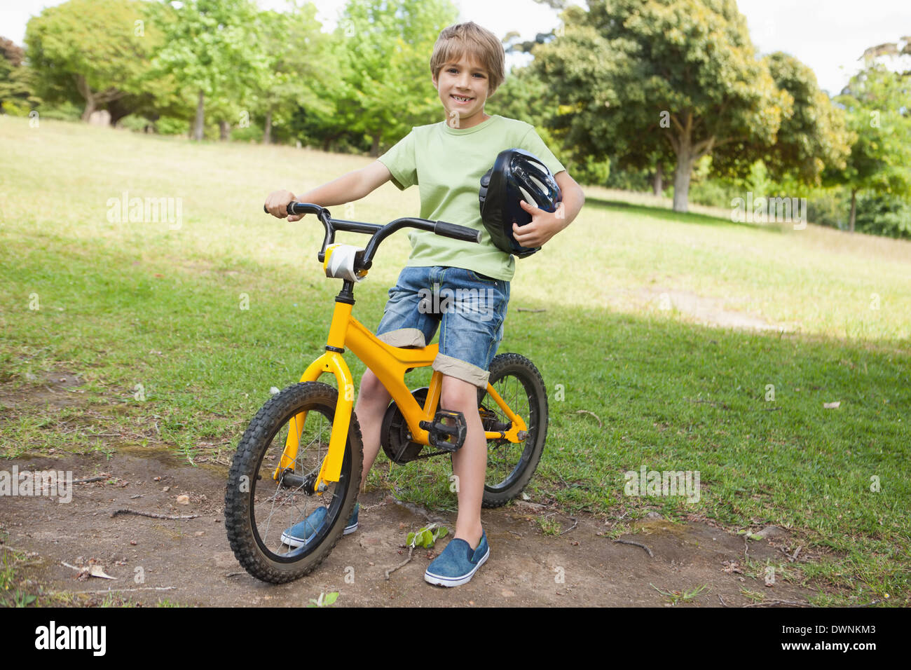Happy smiling boy riding bike hi-res stock photography and images - Alamy