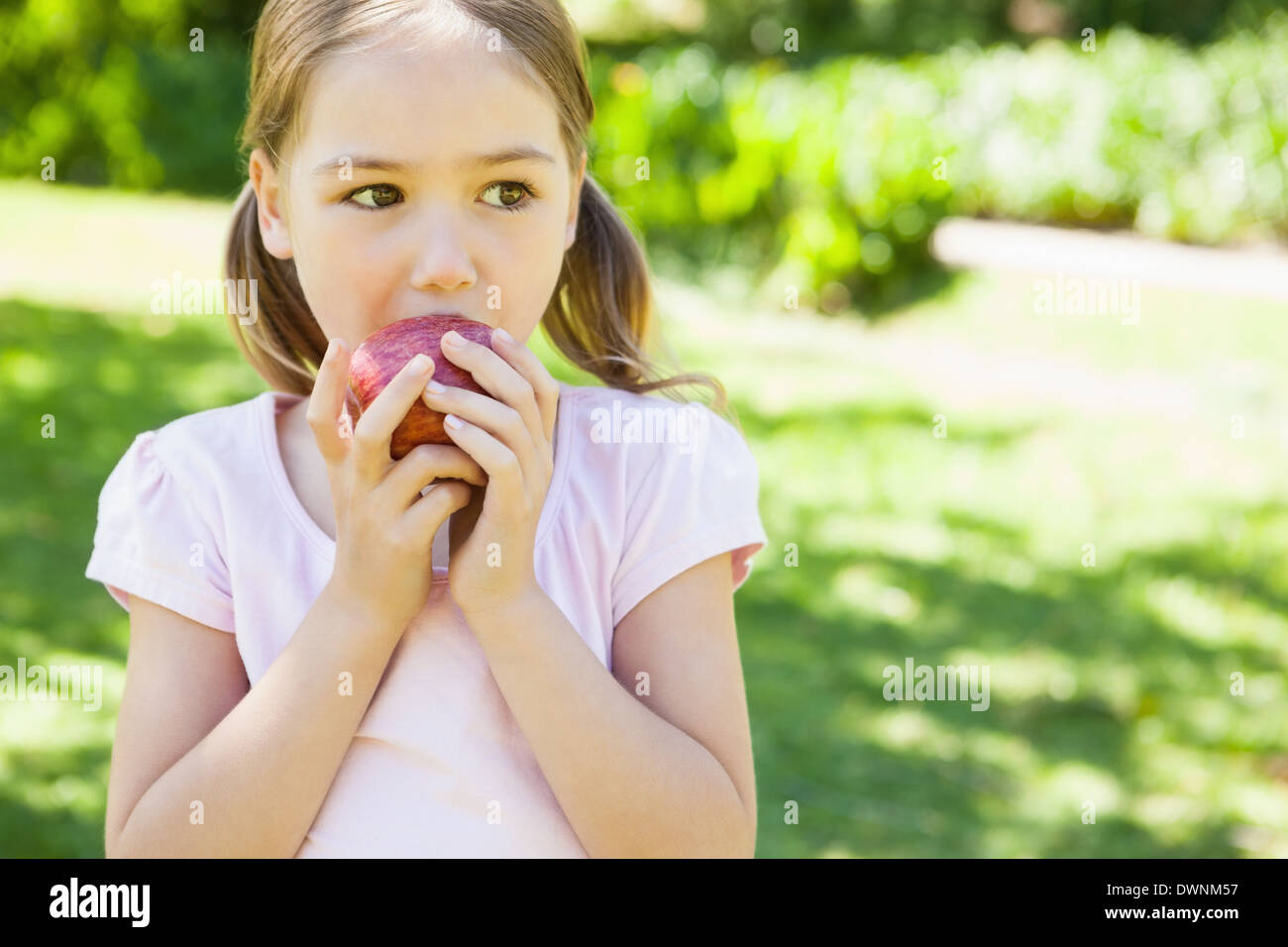Blonde girl eating apple hi-res stock photography and images - Alamy
