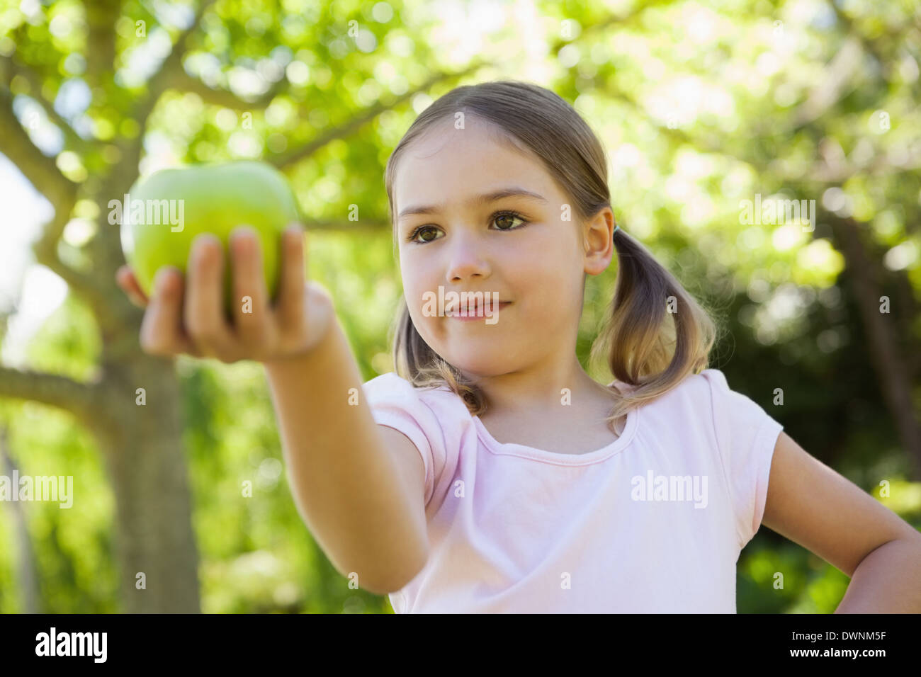 Blonde girl holding apple hi-res stock photography and images - Alamy