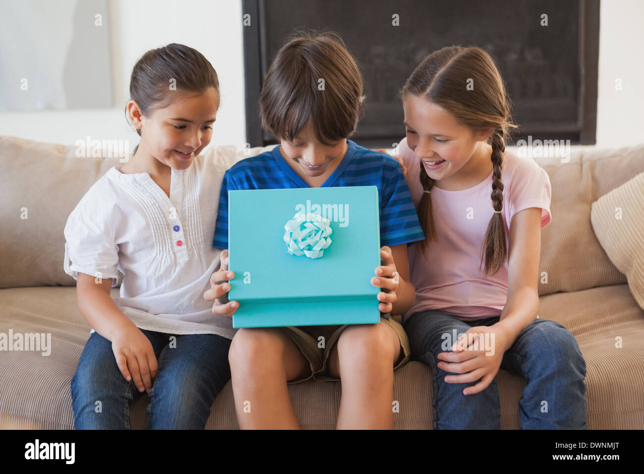 Happy young kids with gift box Stock Photo - Alamy