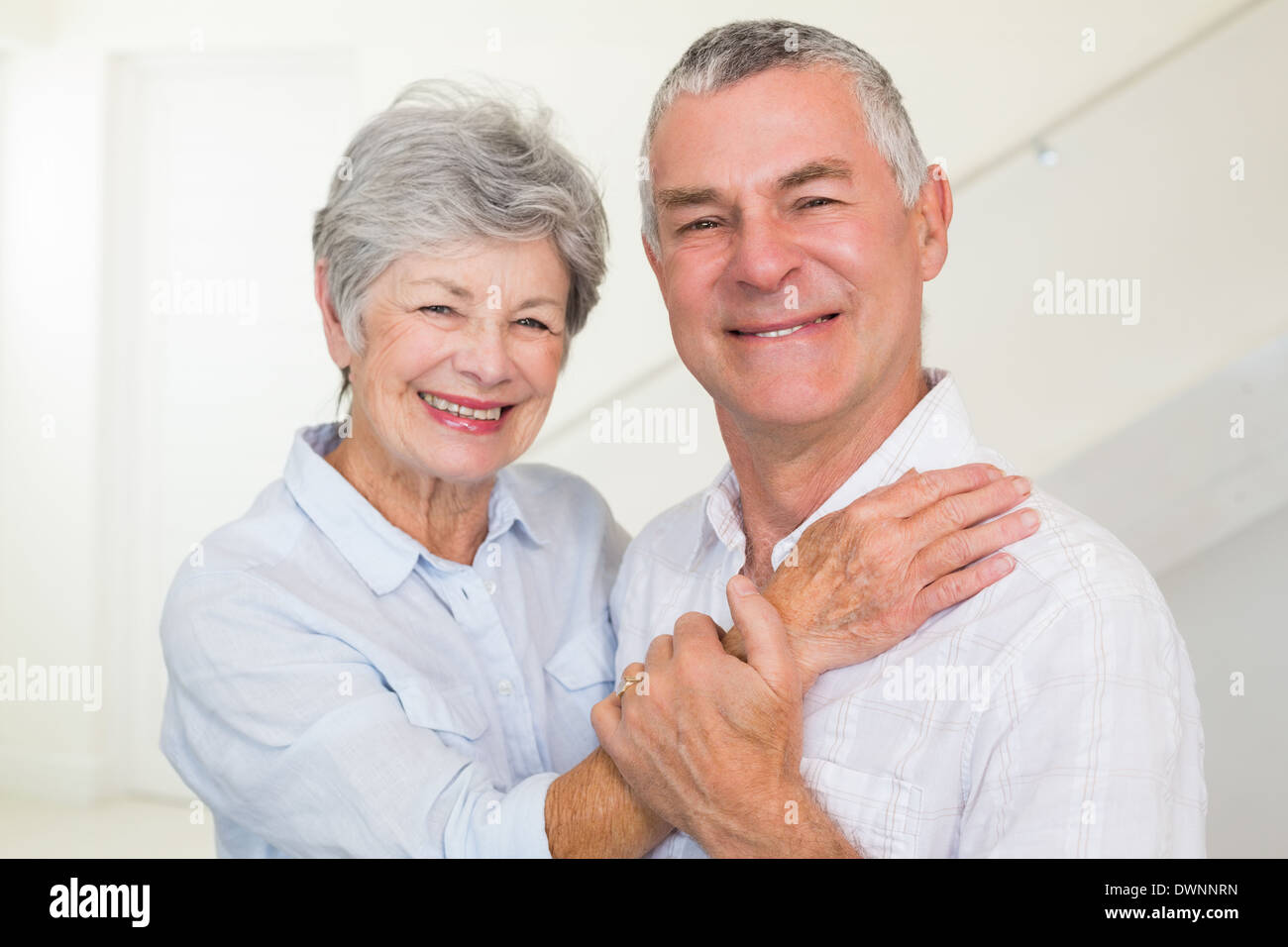Cute retired couple smiling at camera Stock Photo - Alamy