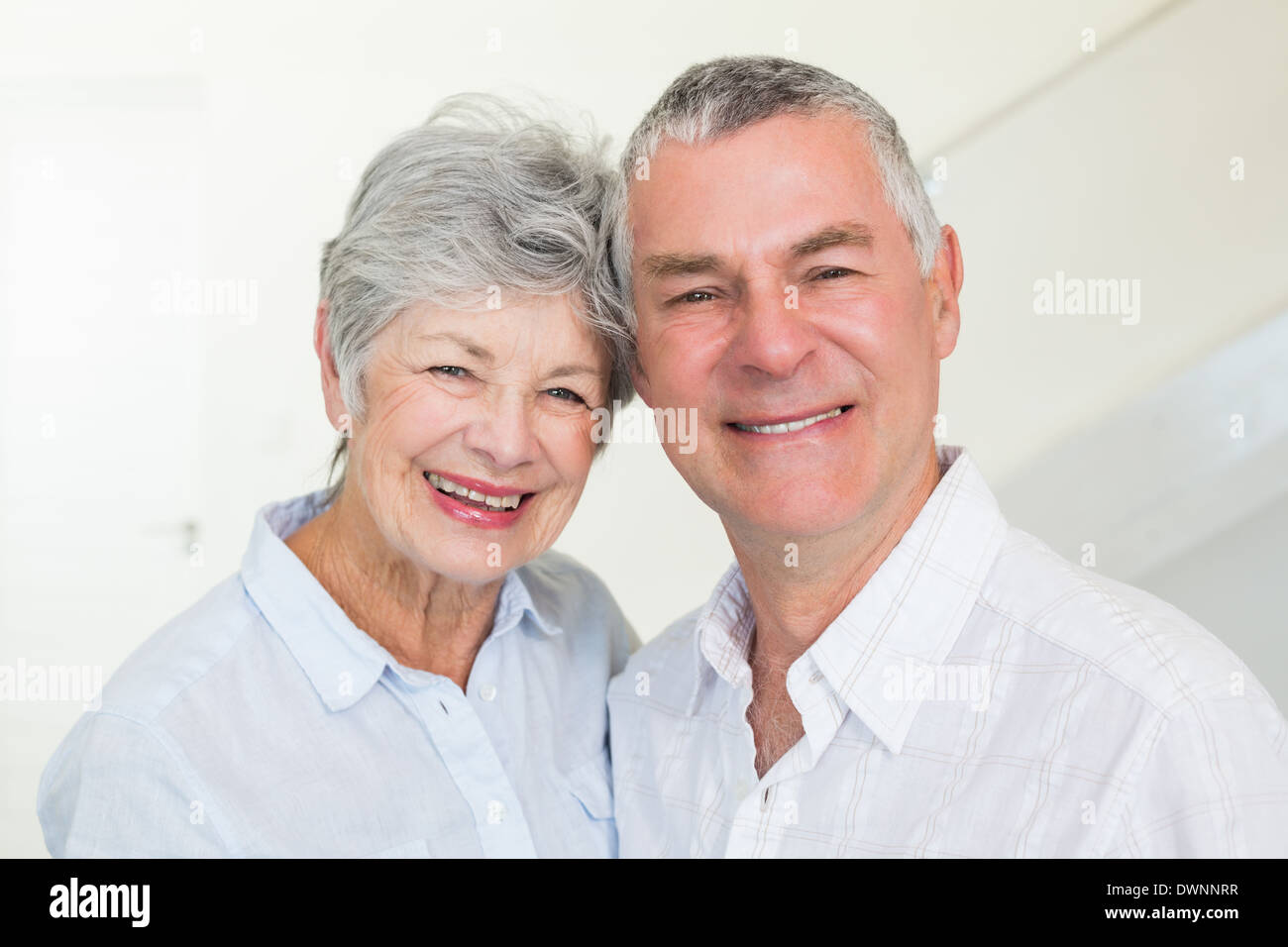 Happy retired couple smiling at camera Stock Photo - Alamy
