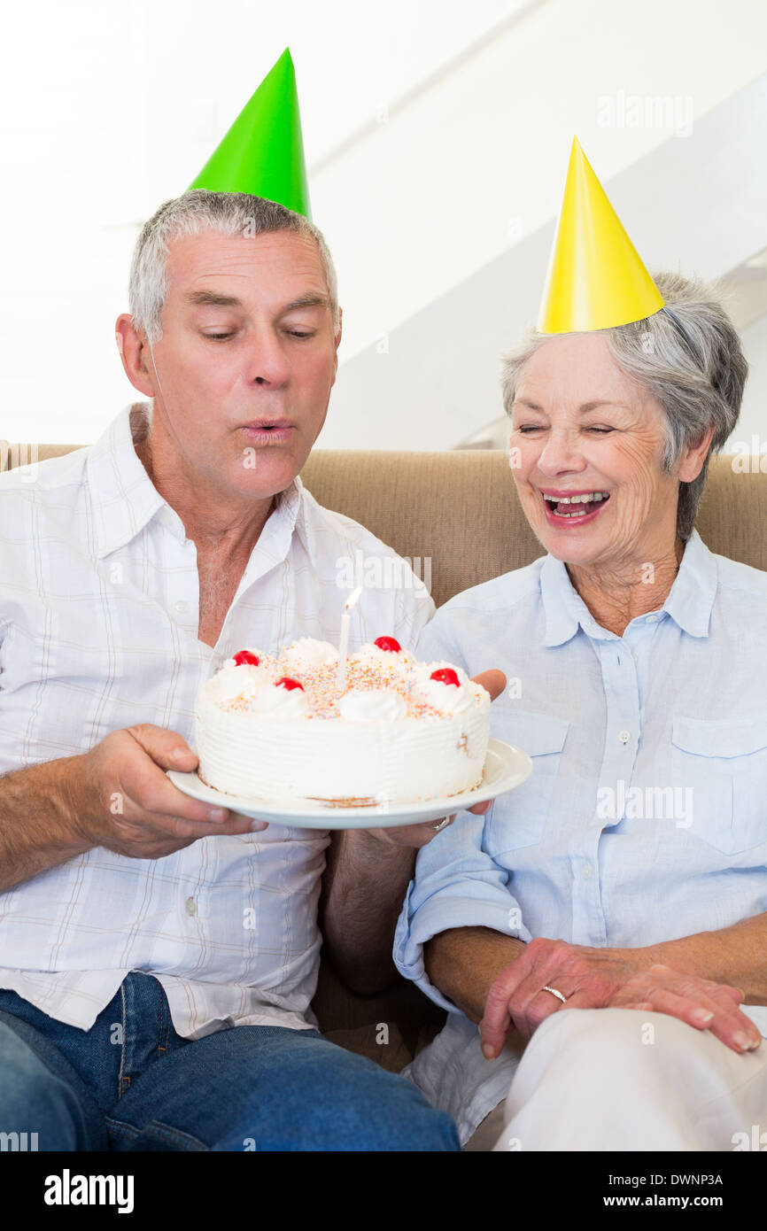 Senior couple sitting on couch celebrating a birthday Stock Photo - Alamy