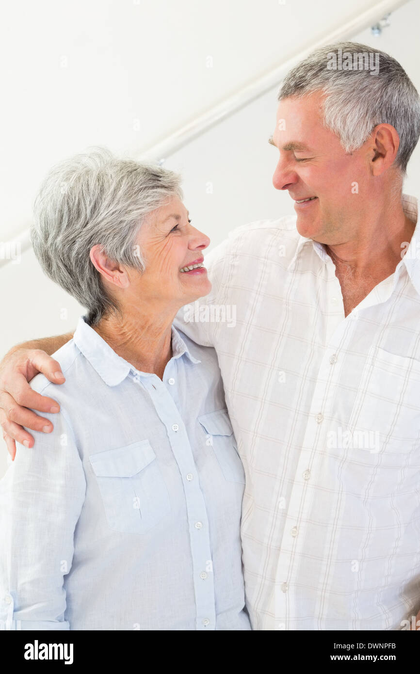 Happy retired couple standing and smiling at each other Stock Photo - Alamy