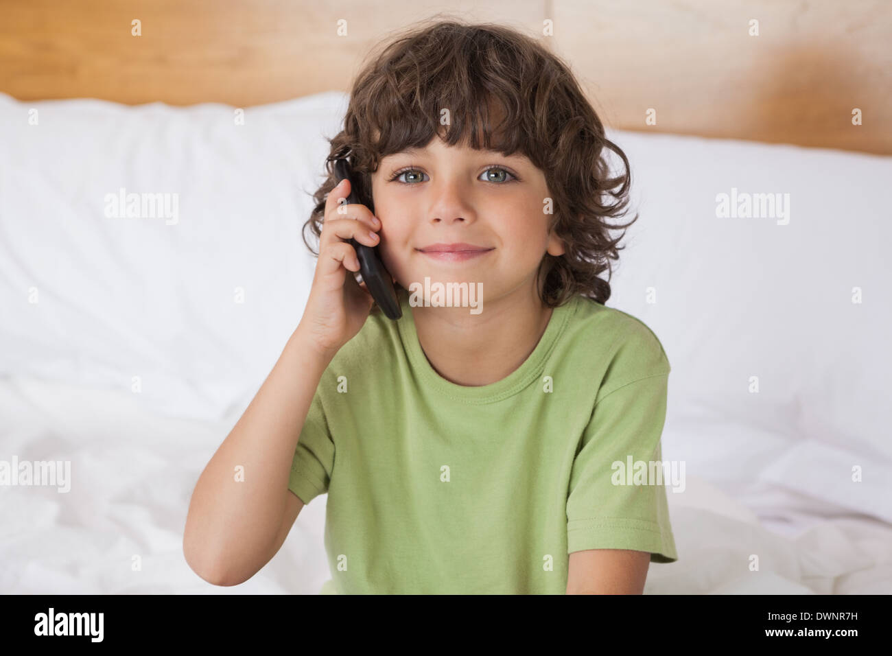 Portrait of young boy using mobile phone in bed Stock Photo - Alamy