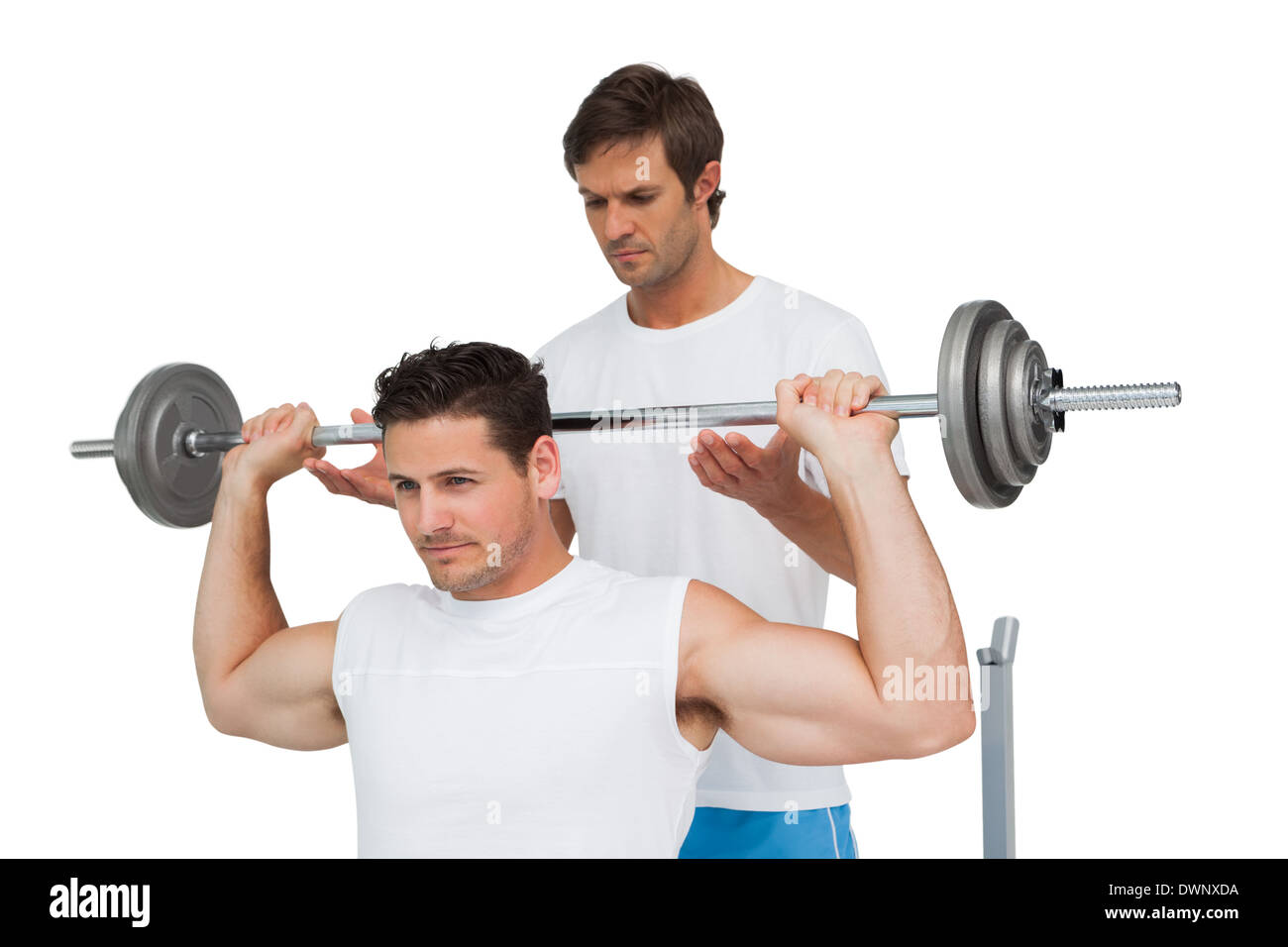 Trainer helping fit man to lift the barbell bench press Stock Photo - Alamy