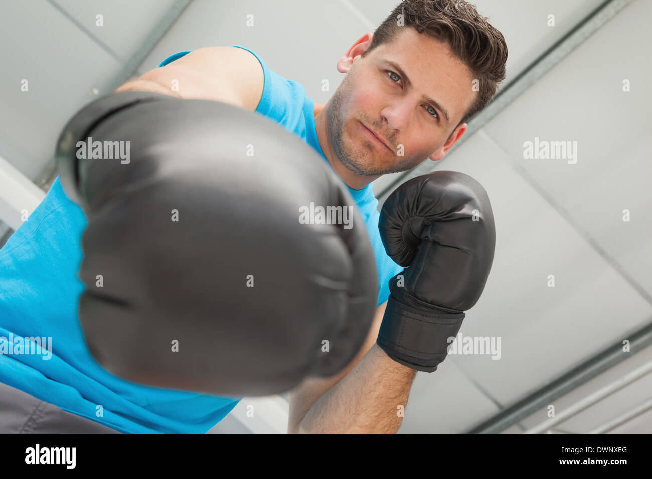 Determined male boxer focused on his training over white background ...