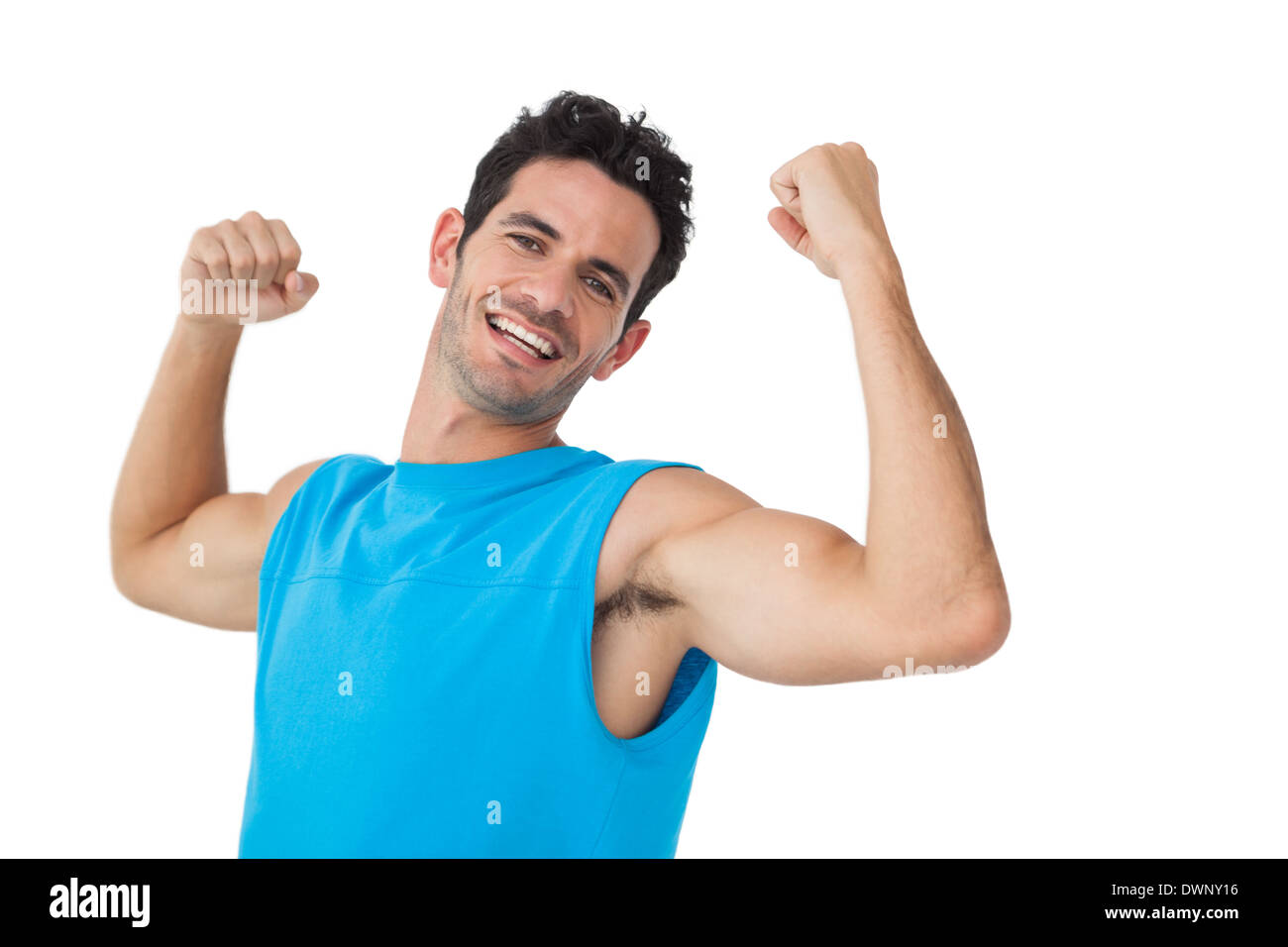 Portrait of a smiling young man flexing muscles Stock Photo - Alamy