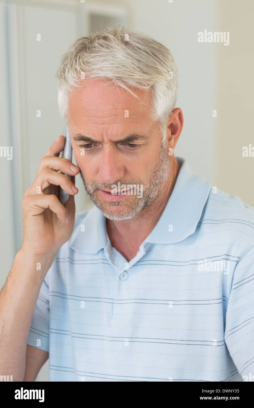 Serious man on a phone call Stock Photo - Alamy