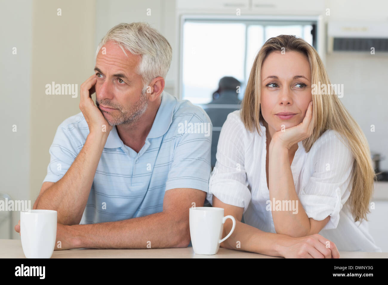 Bored couple sitting at the counter Stock Photo - Alamy