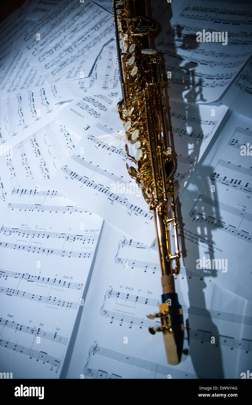 A soprano saxophone lying on sheet music Stock Photo - Alamy