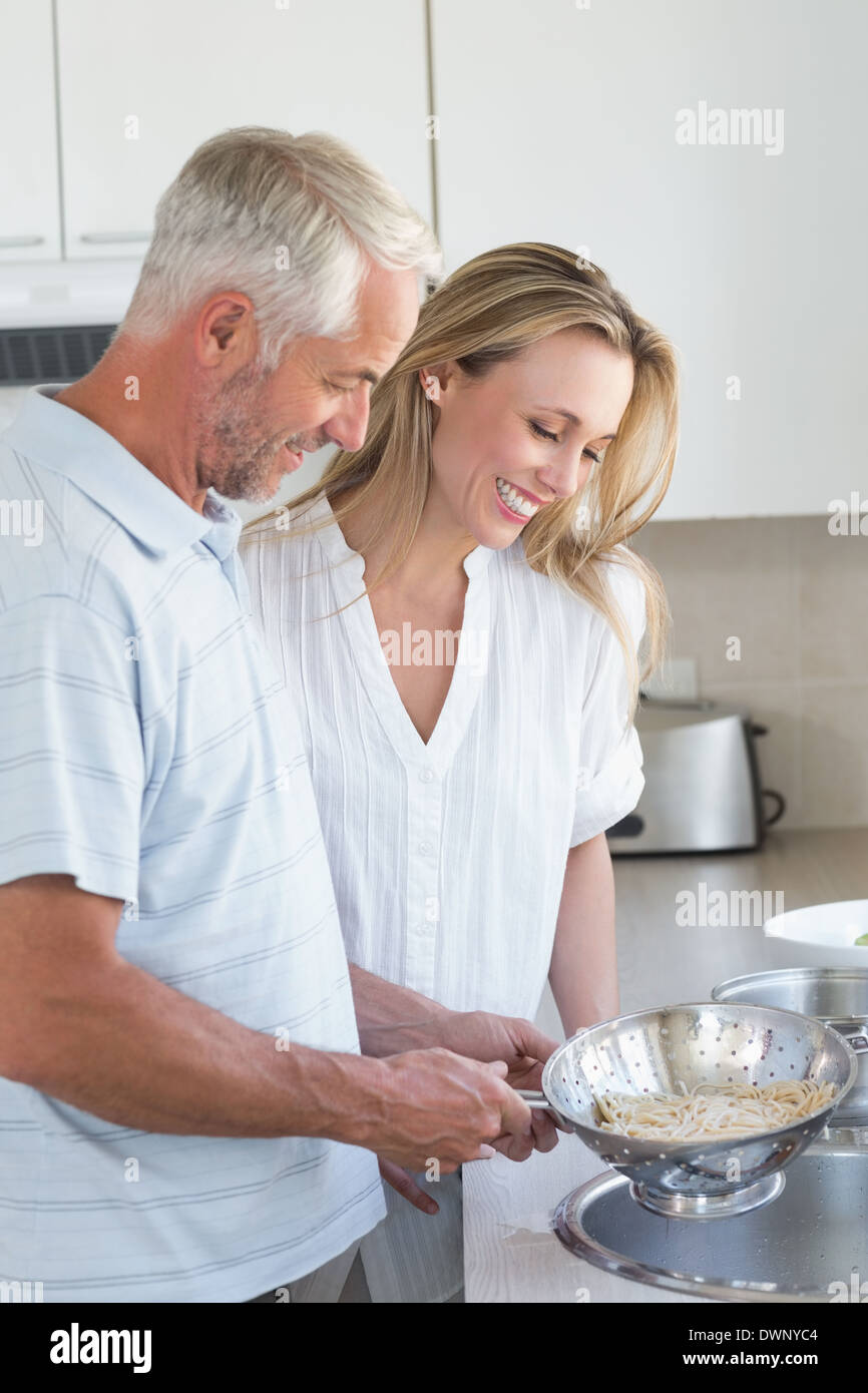 Couple draining spaghetti in colander Stock Photo - Alamy