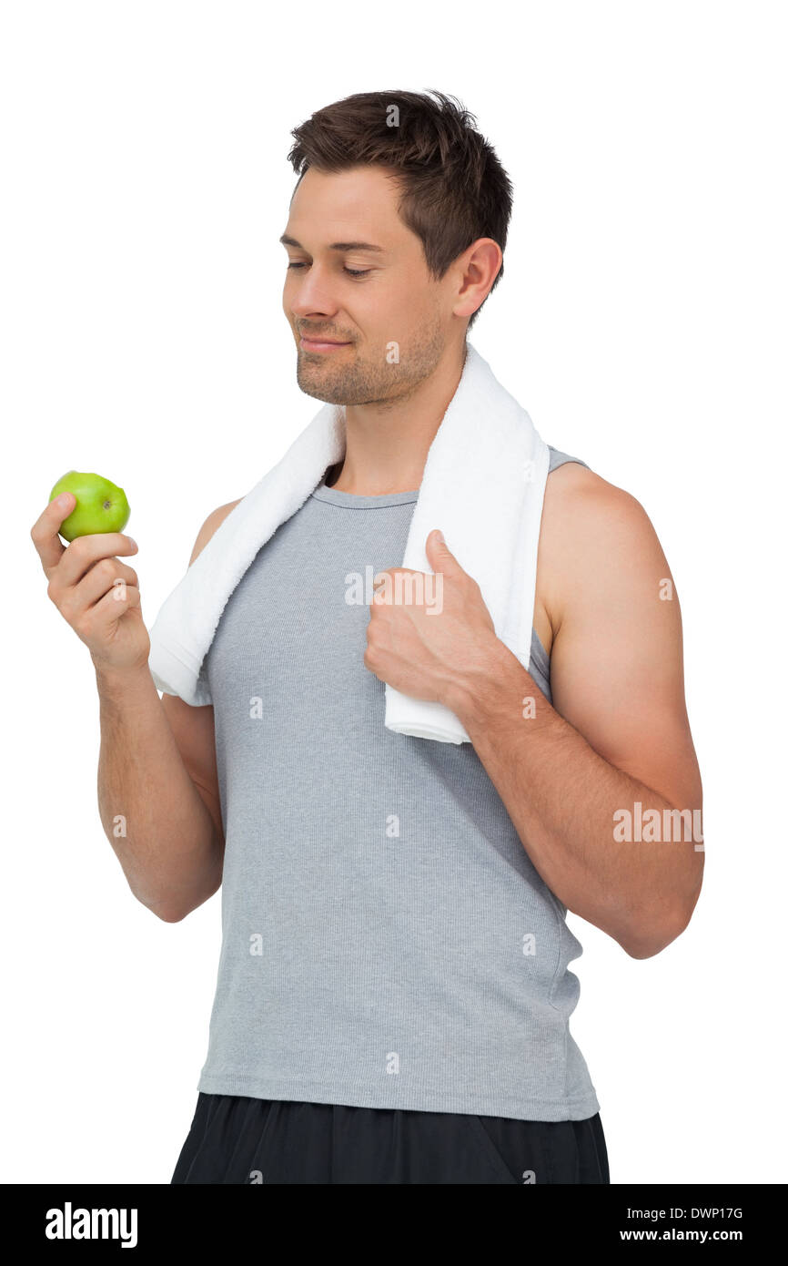 Portrait of a smiling fit young man with apple Stock Photo - Alamy