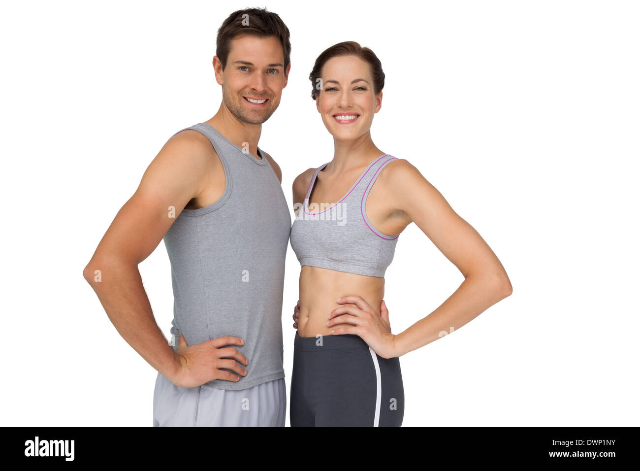 Portrait of a happy fit couple with hands on hips Stock Photo - Alamy