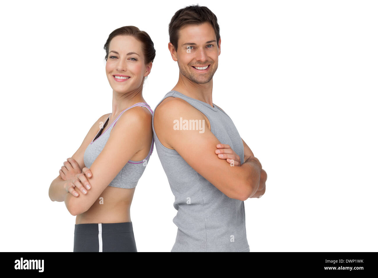 Portrait of a happy fit young couple with hands crossed Stock Photo - Alamy
