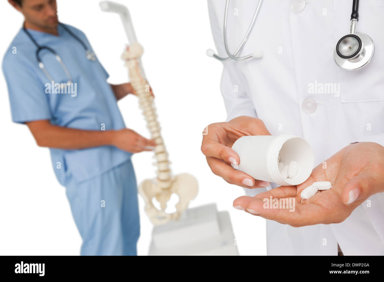 Mid section of female doctor with pills and skeleton model Stock Photo ...