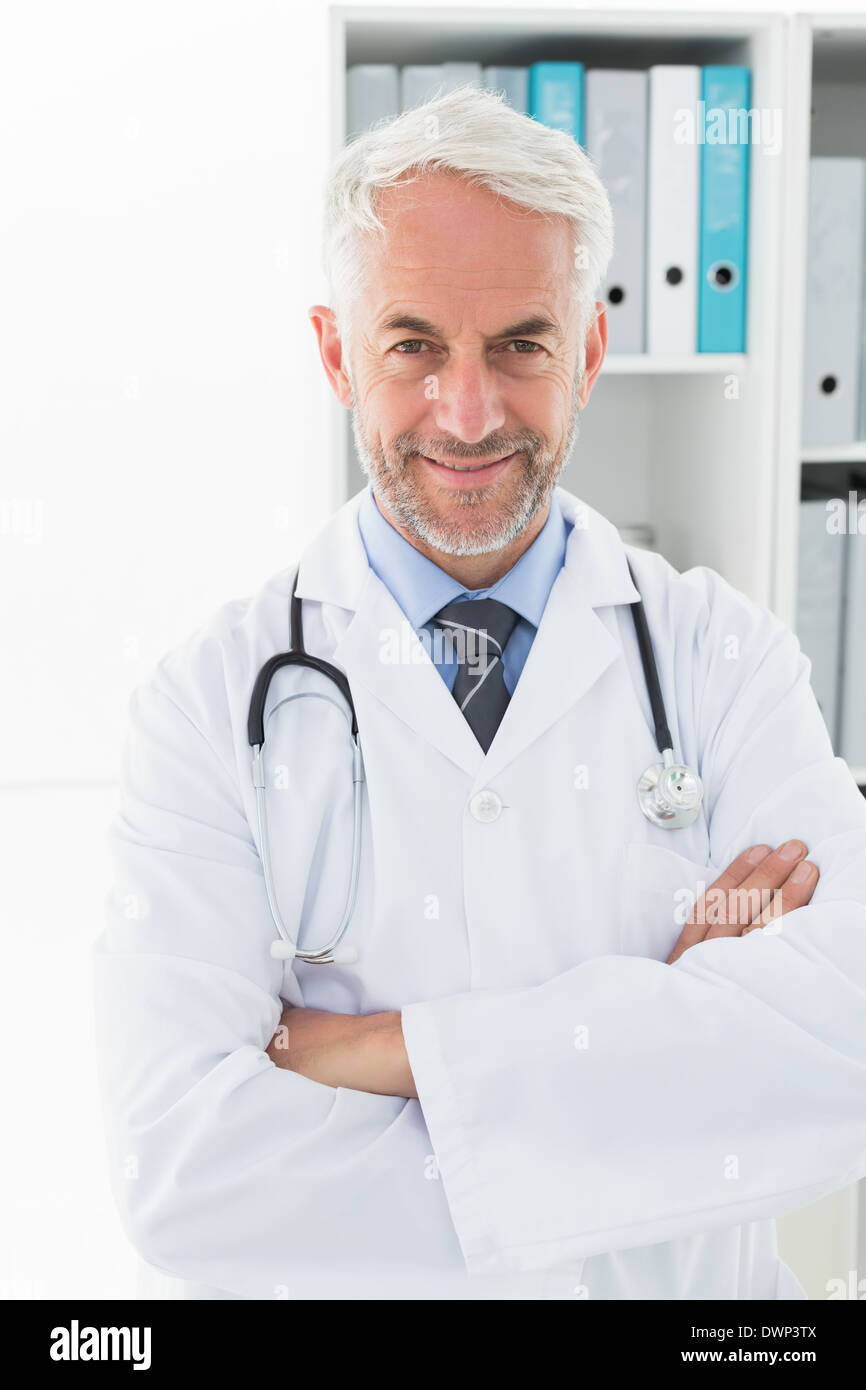 Smiling confident male doctor at medical office Stock Photo - Alamy
