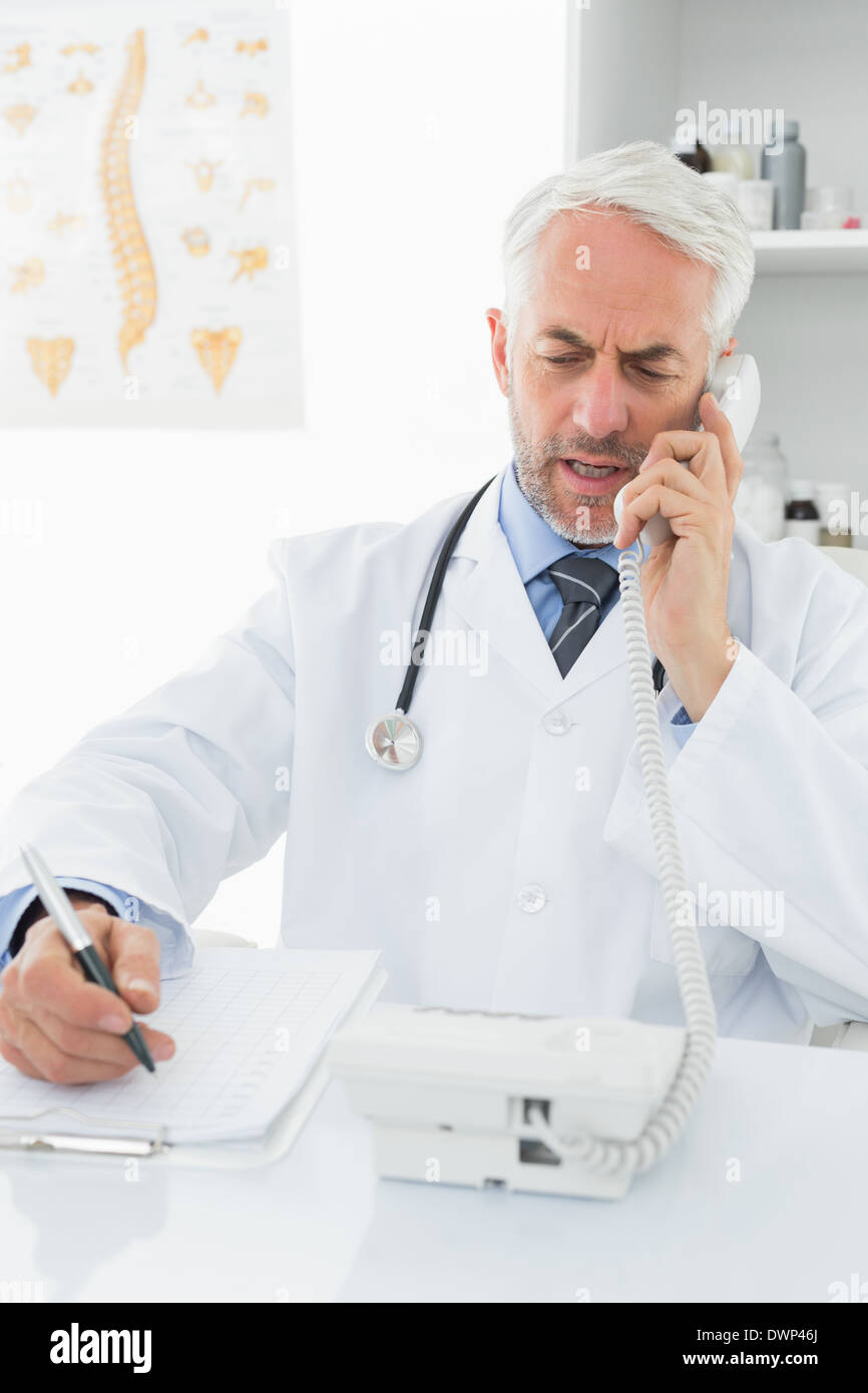 Doctor calling holding pen hi-res stock photography and images - Alamy