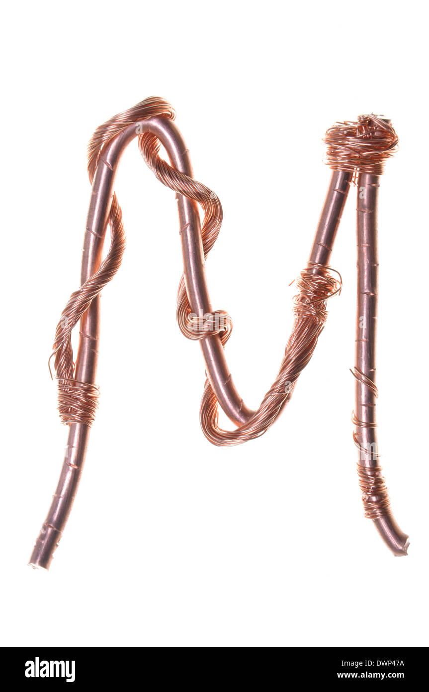 Twisted copper wire in the shape of the letter M Stock Photo - Alamy