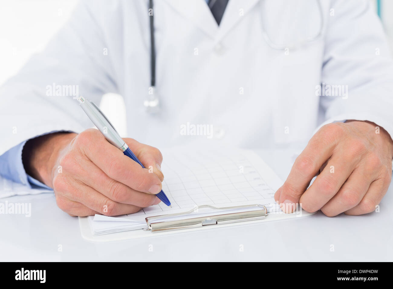 Mid section of a doctor writing on clipboard Stock Photo - Alamy