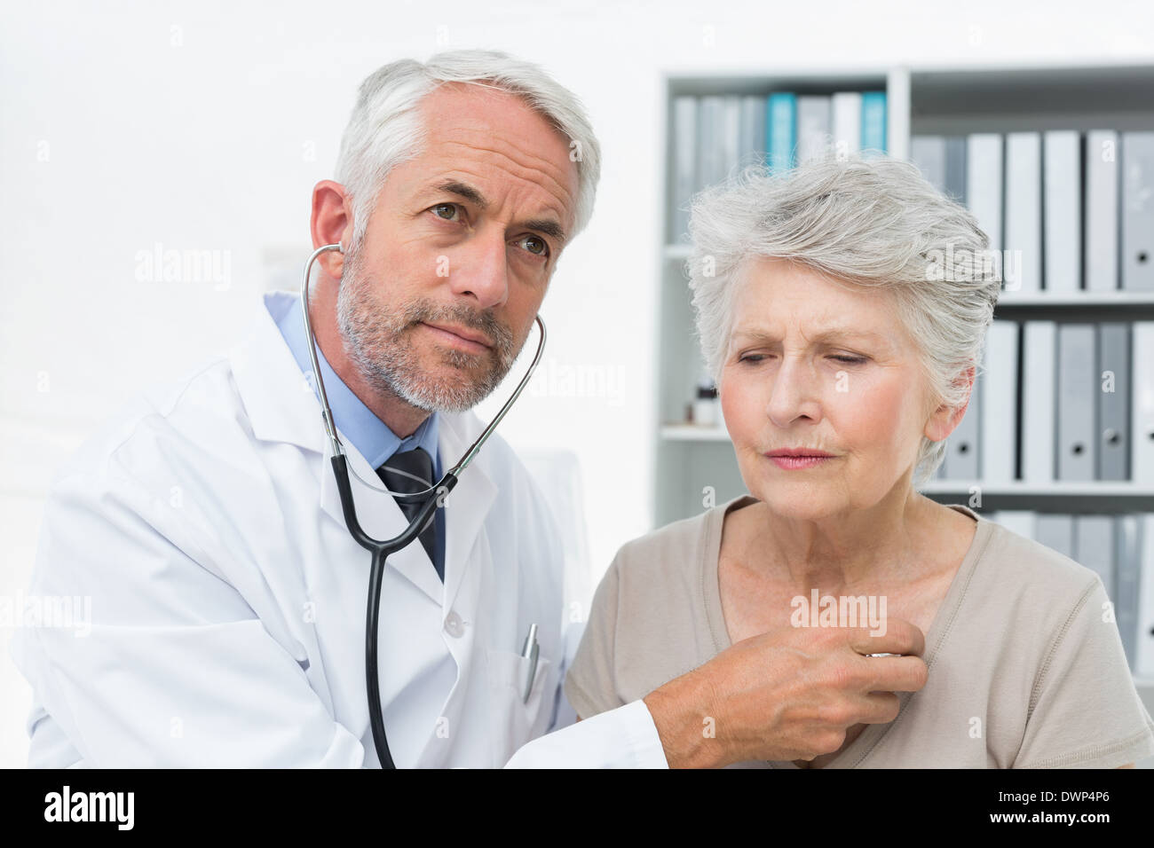 Doctor checking patients heartbeat using stethoscope Stock Photo - Alamy
