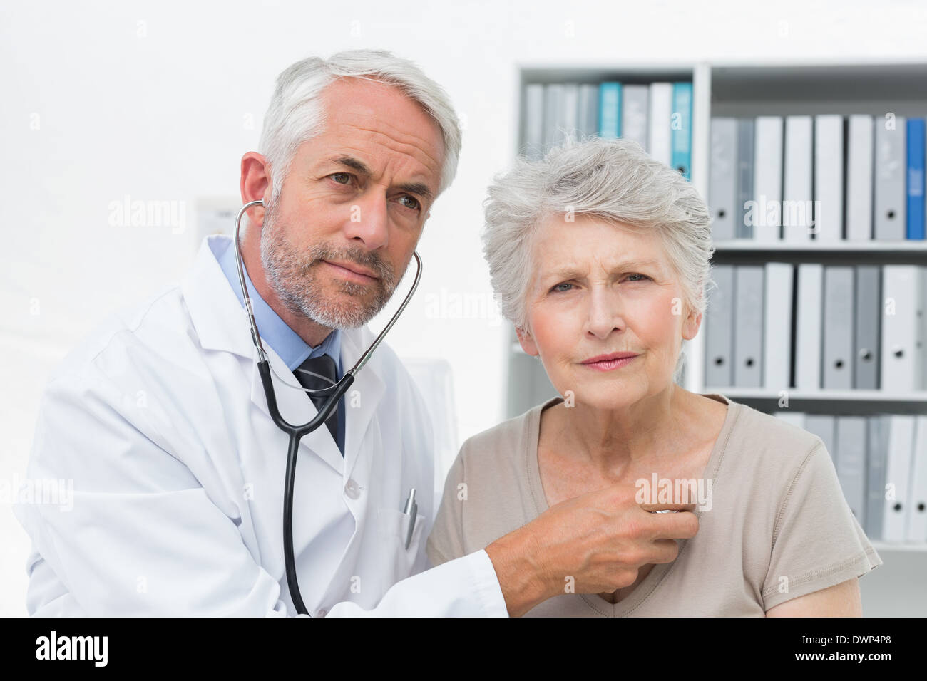 Doctor checking patients heartbeat using stethoscope Stock Photo - Alamy