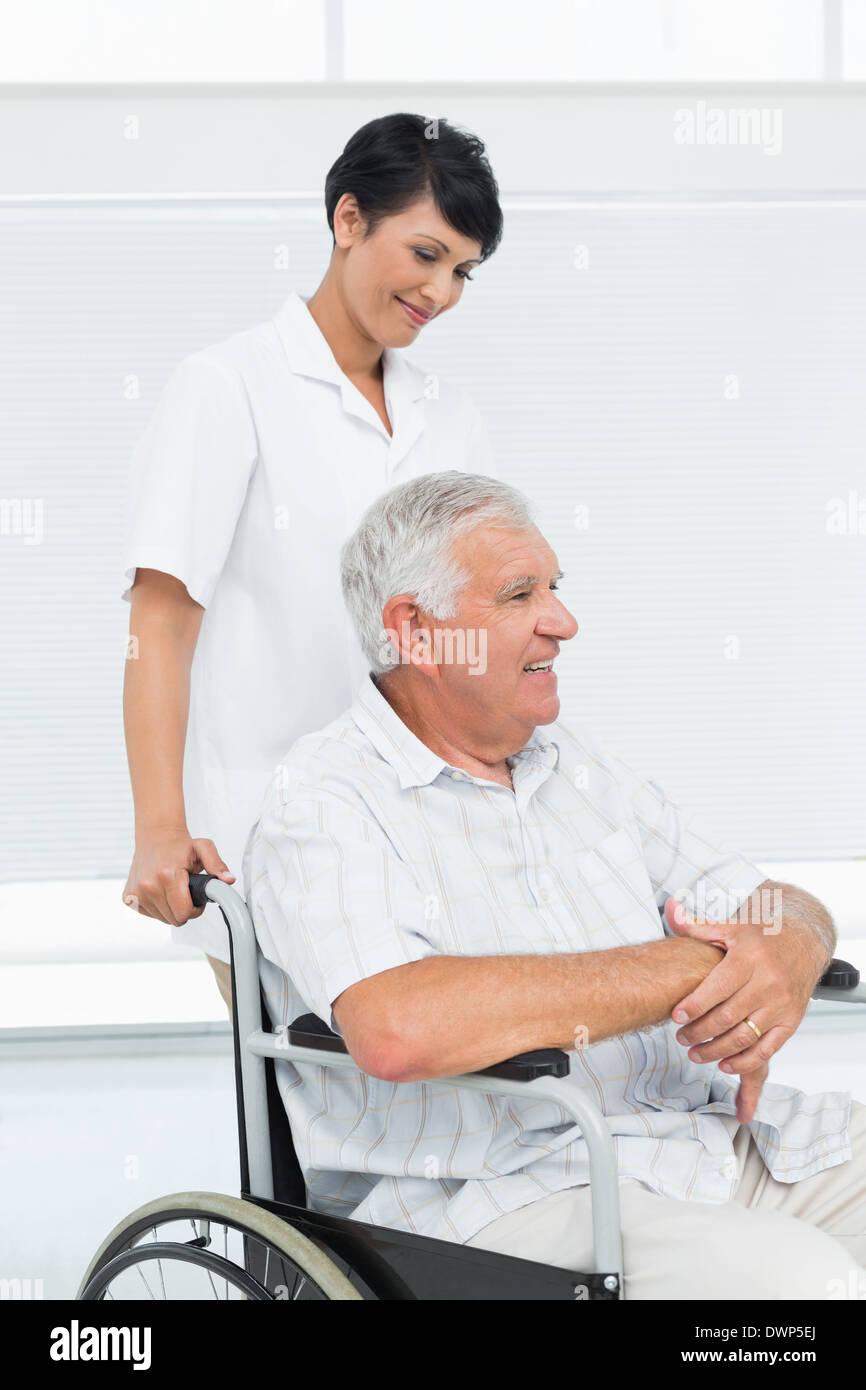 Nurse with senior patient sitting in wheelchair Stock Photo - Alamy