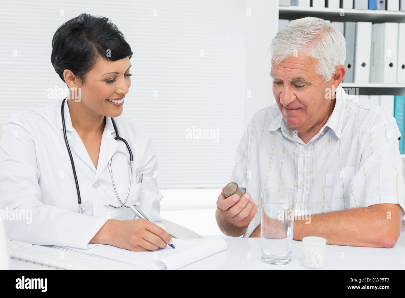 Doctor explaining reports to male patient Stock Photo - Alamy