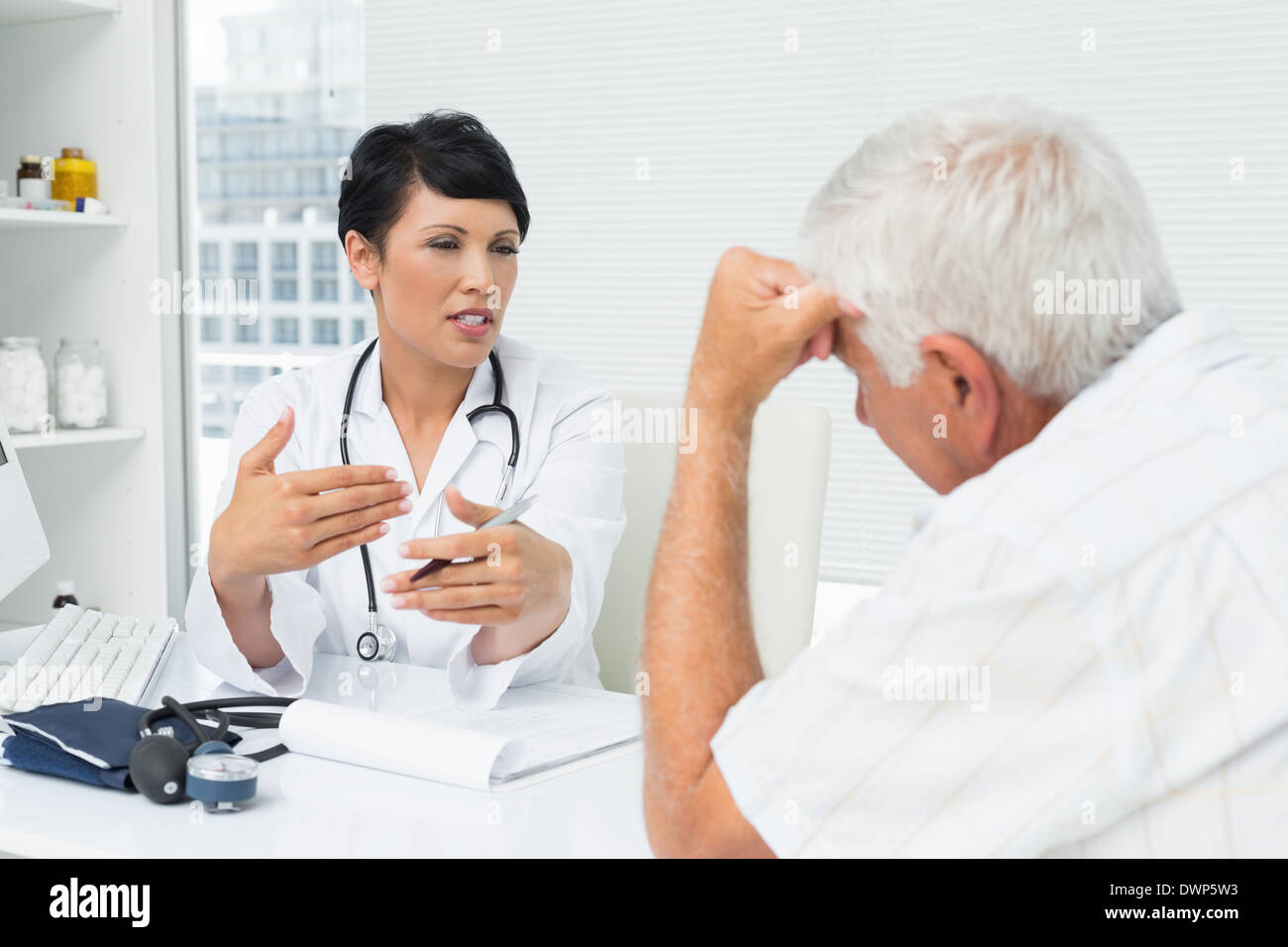 Female doctor explaining reports to senior patient at medical office ...