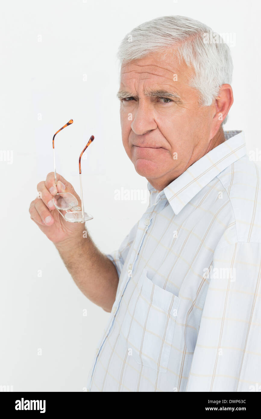 Senior man holding glasses hi-res stock photography and images - Alamy
