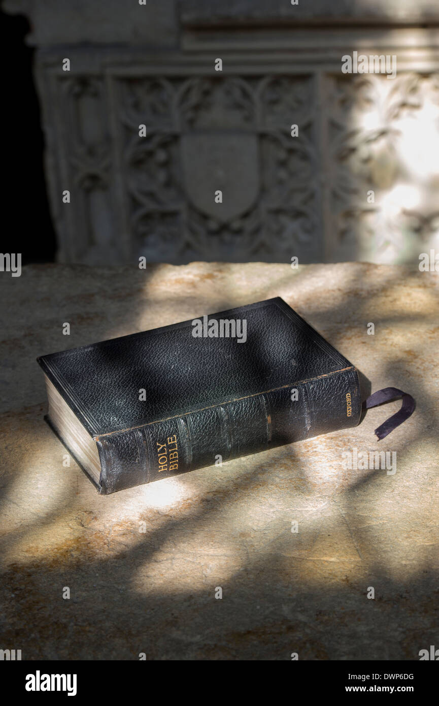 Holy Bible in a church lit up by sunlight. UK Stock Photo - Alamy