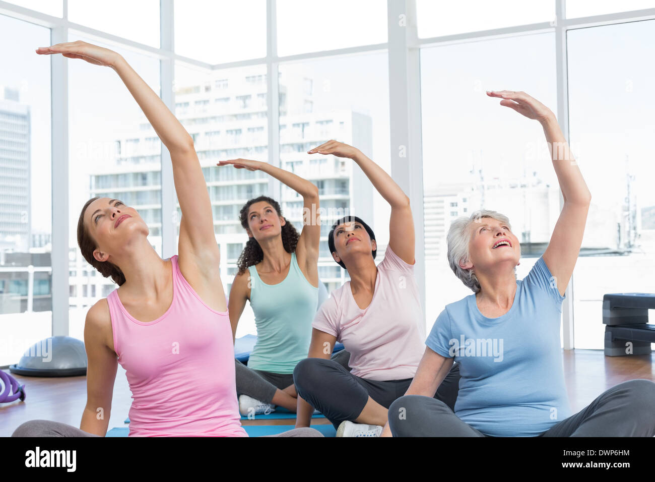 Class stretching hands at yoga class Stock Photo - Alamy