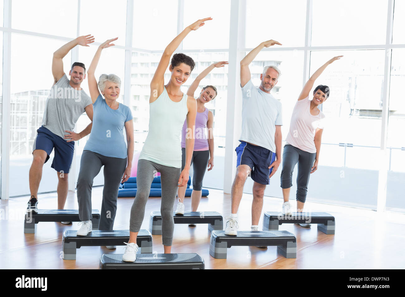 Class stretching hands in yoga class Stock Photo - Alamy