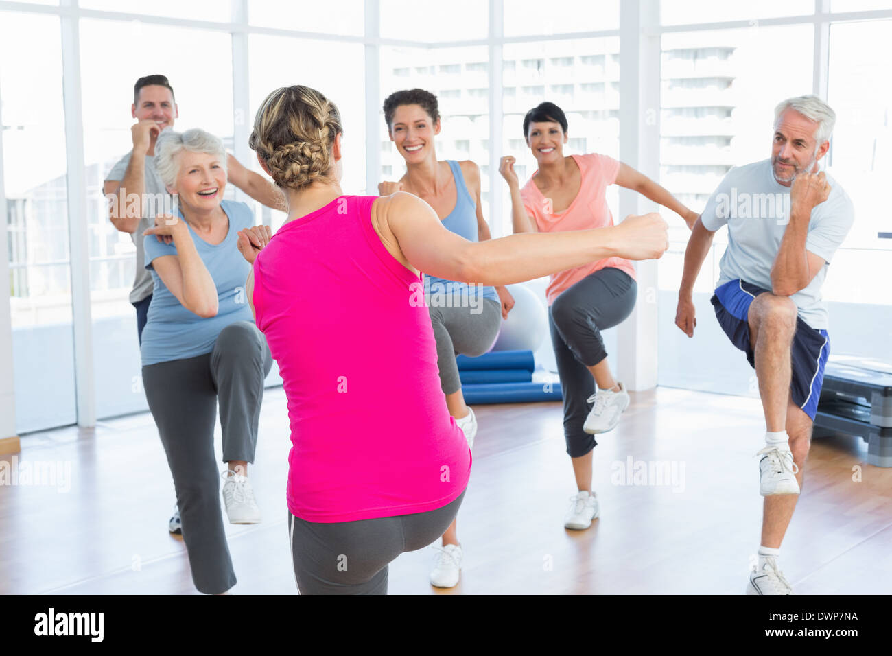 People doing power fitness exercise at yoga class in fitness studio ...