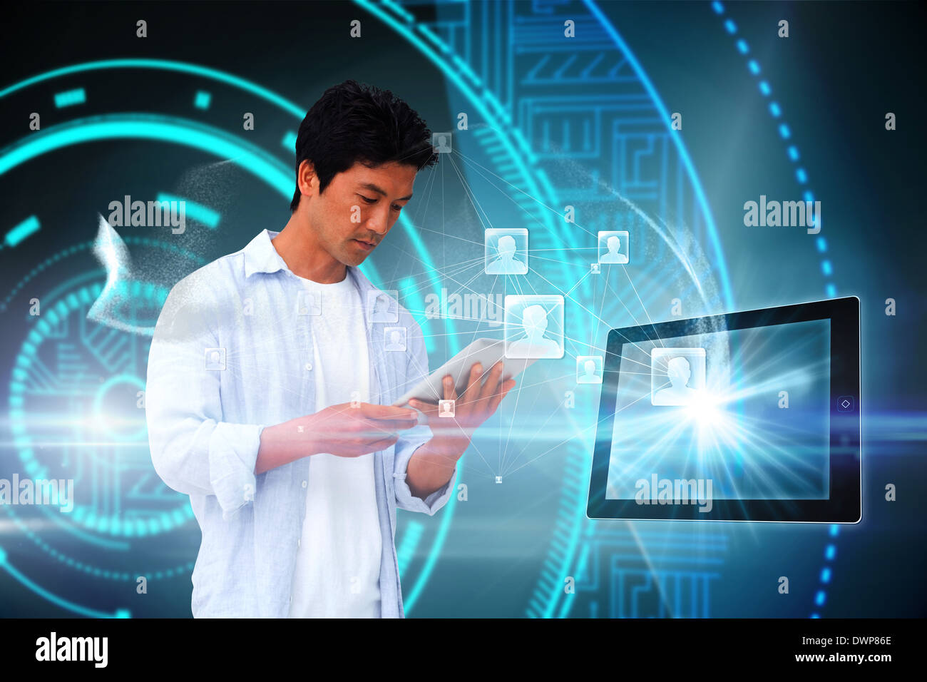 Casual man using tablet with profile icons Stock Photo - Alamy