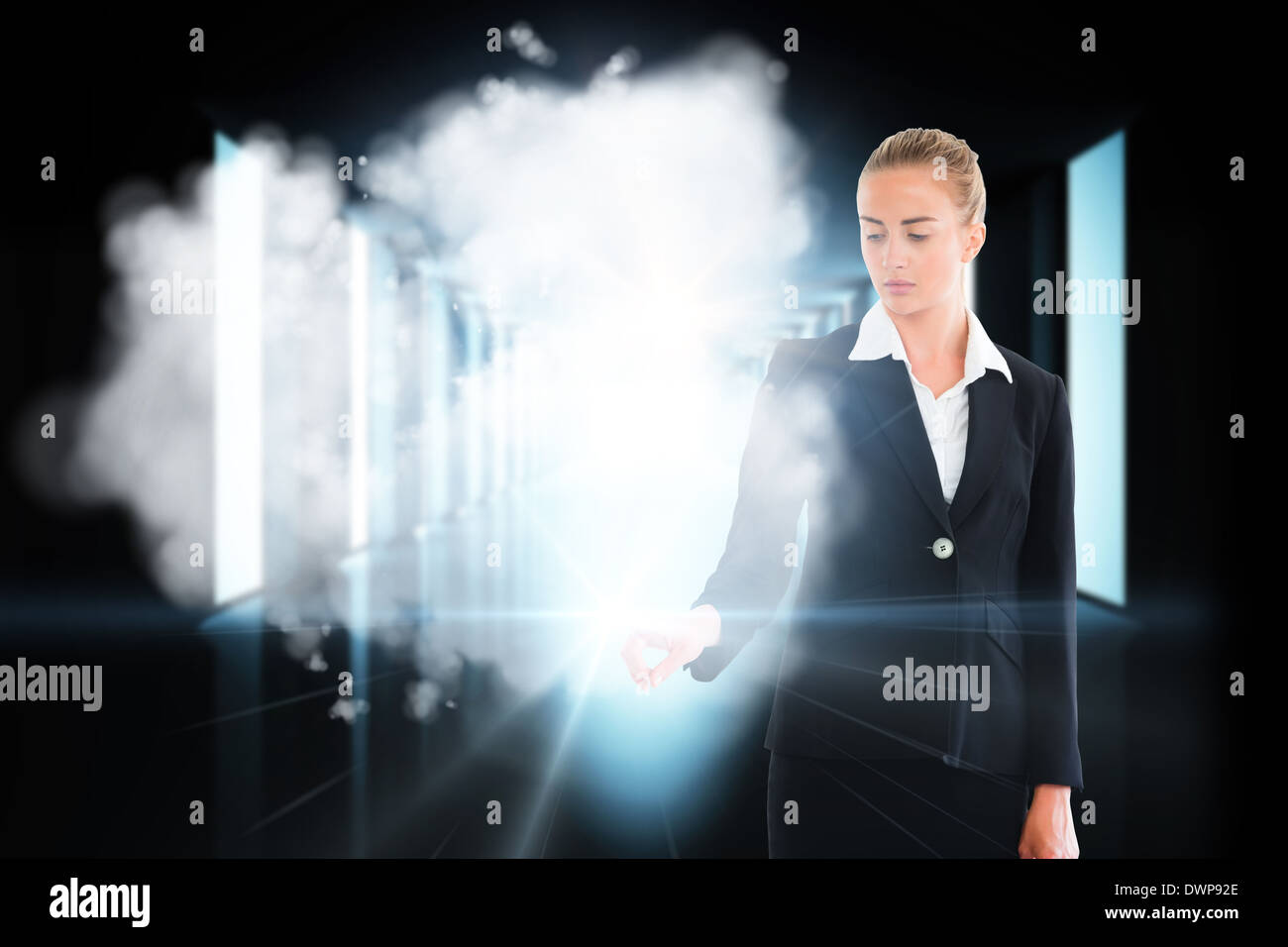 Blonde businesswoman touching light Stock Photo - Alamy