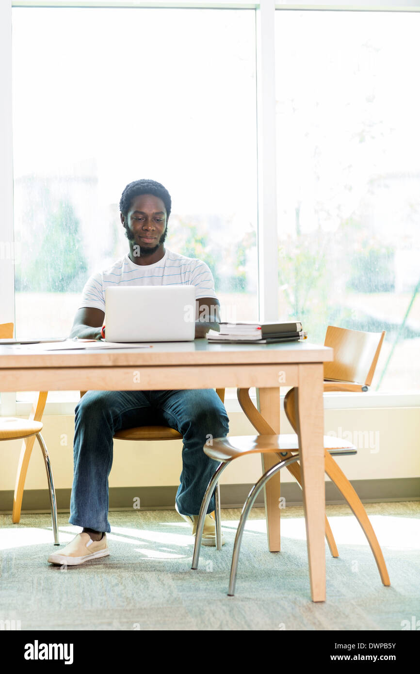 Student Using Laptop In Library Stock Photo - Alamy