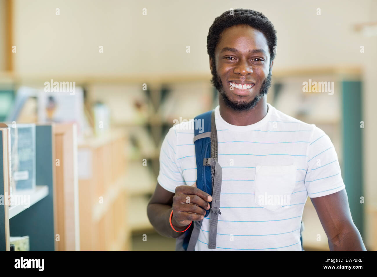 Student Carrying Backpack In Library Stock Photo - Alamy