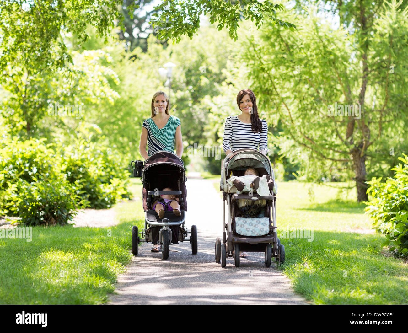 Pushing baby strollers hi-res stock photography and images - Alamy