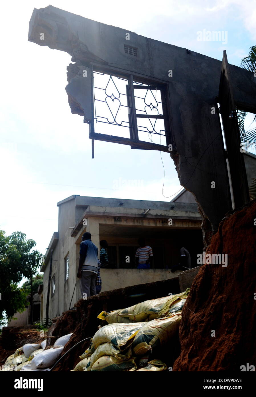 Destroyed houses stand in the Bairro de Laulane in Maputo, Mozambique ...