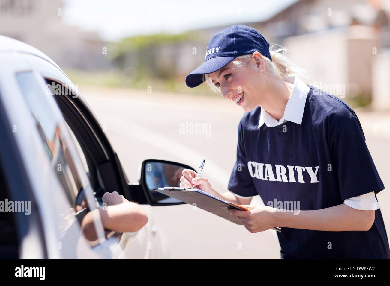 cheerful volunteer raising money for charity on street Stock Photo - Alamy