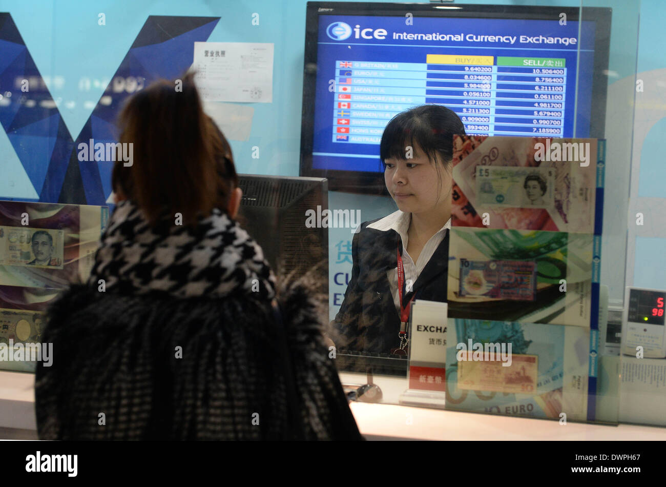 Shanghai. 12th Mar, 2014. A woman exchanges money at a foreign currency ...