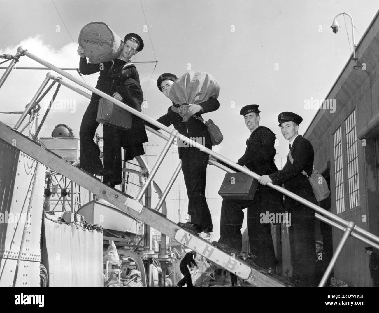 Royal Navy sailors board their ship with kit bags and cases Stock Photo ...