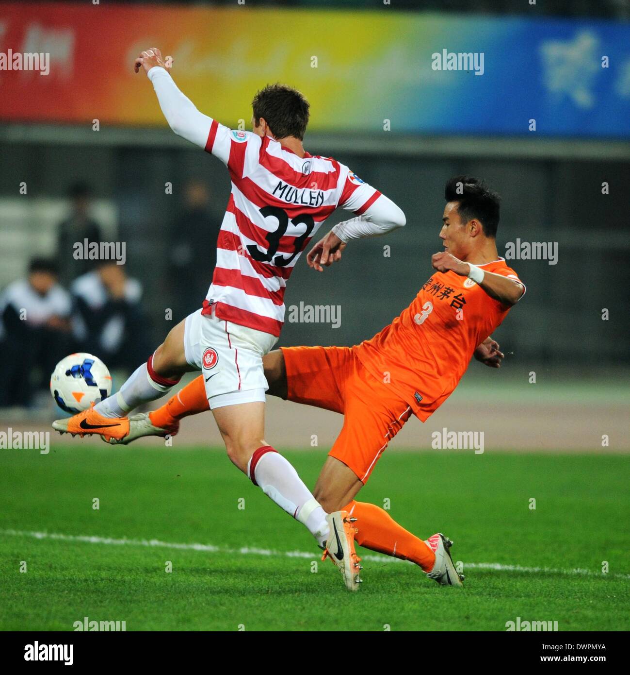 Guiyang. 12th Mar, 2014. Zhang Chenglin (R) of Guizhou Renhe competes ...