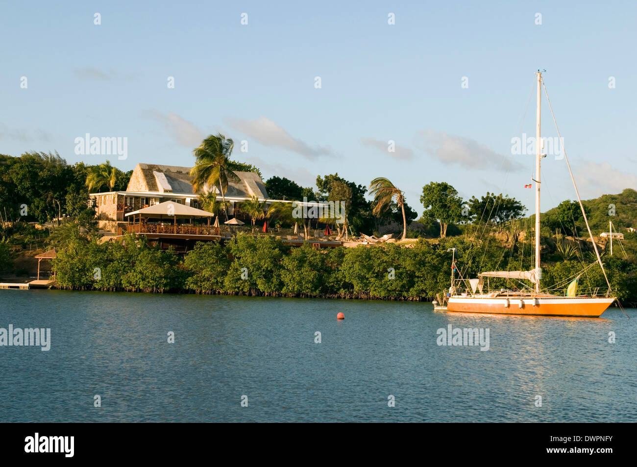 channel in English Harbor with sailboat and luxury villa Antigua ...
