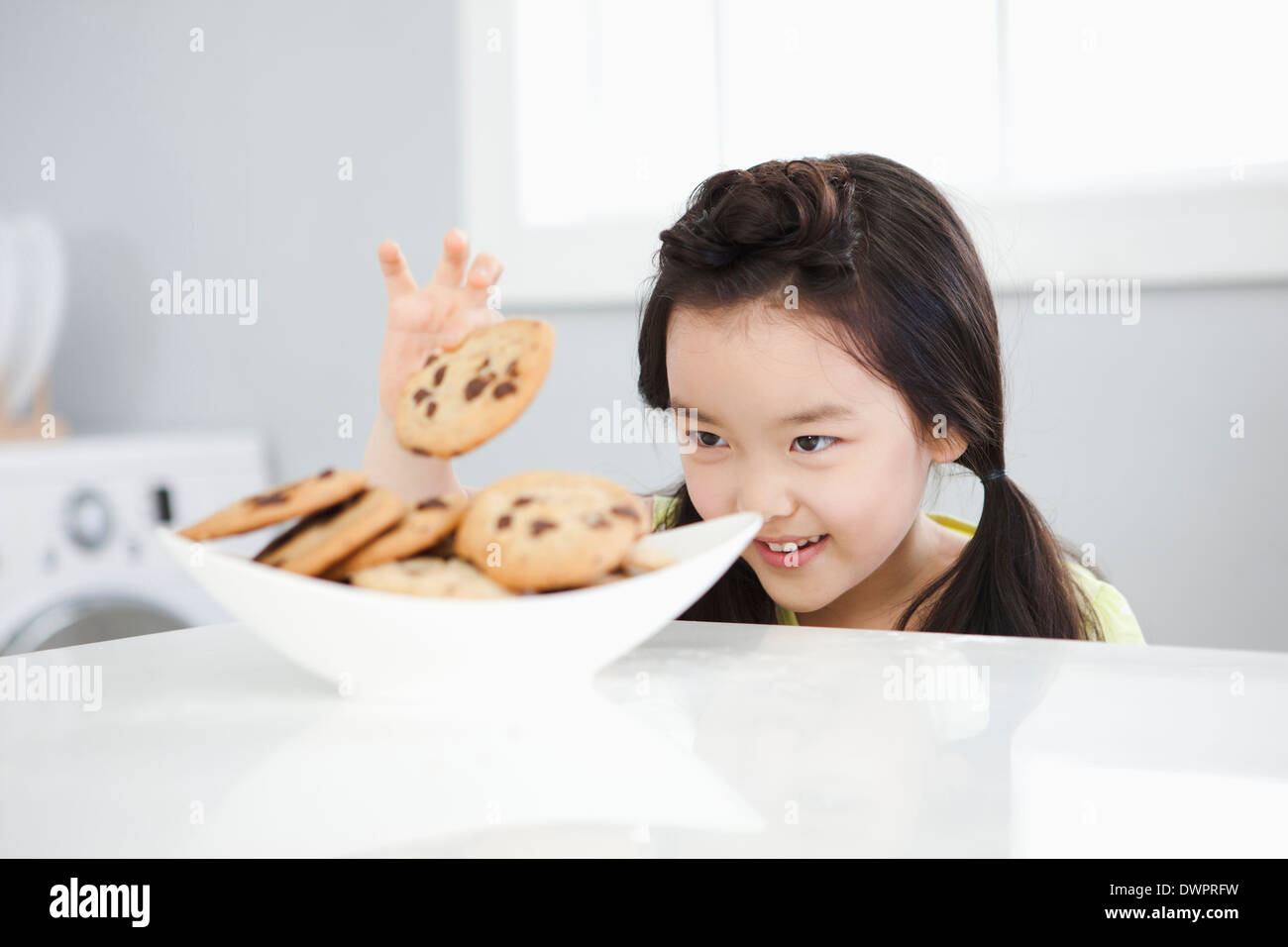 a kid peeking cookies in the kitchen Stock Photo - Alamy