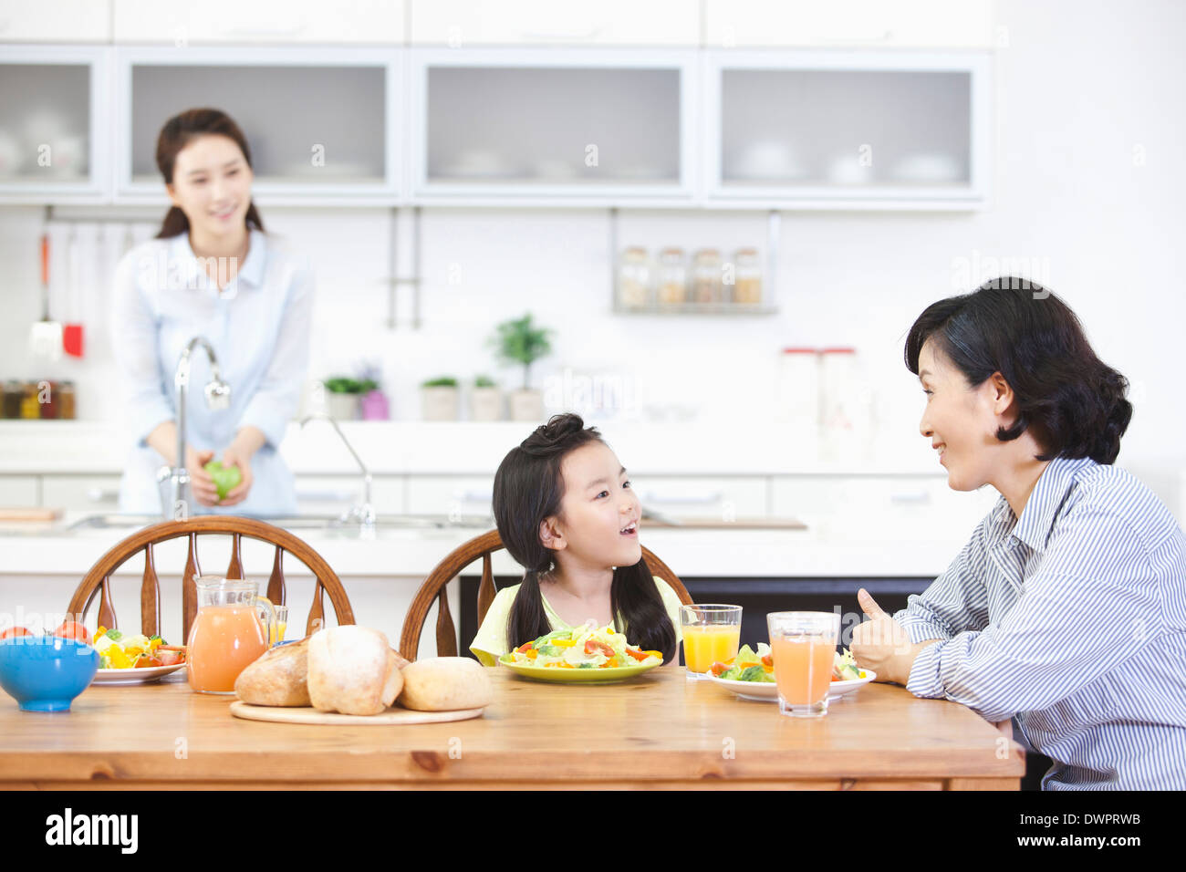 two women and a kid in the kitchen Stock Photo - Alamy